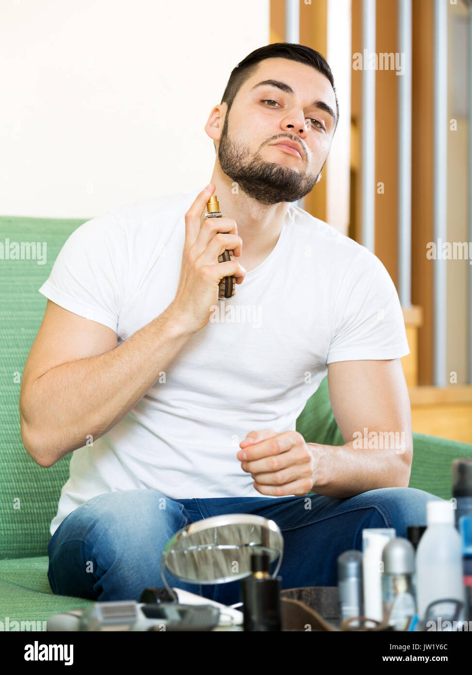 portrait handsome young man applying perfume for keeping fresh Stock ...
