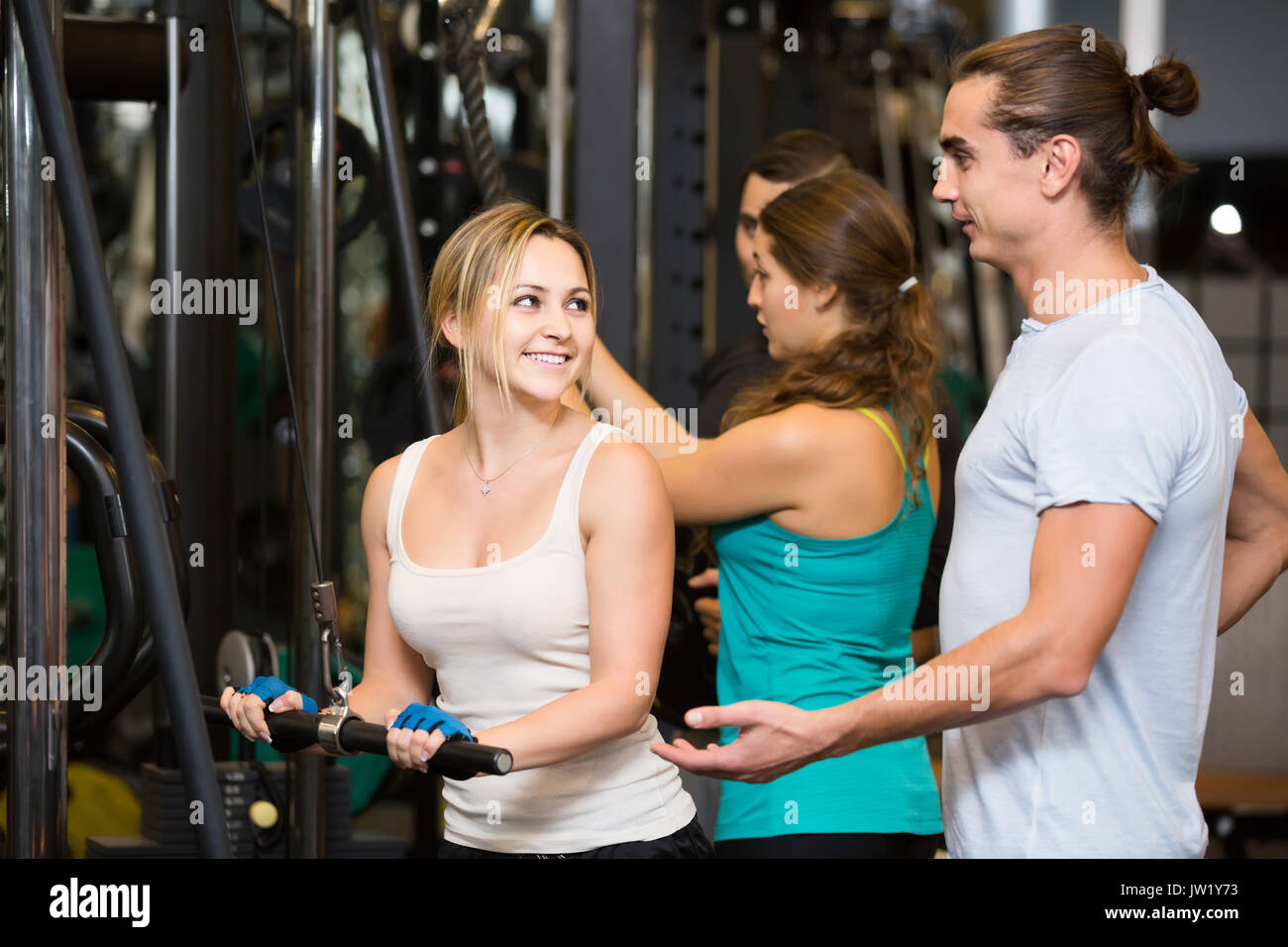 happy russian adults having strength training under coach control in ...
