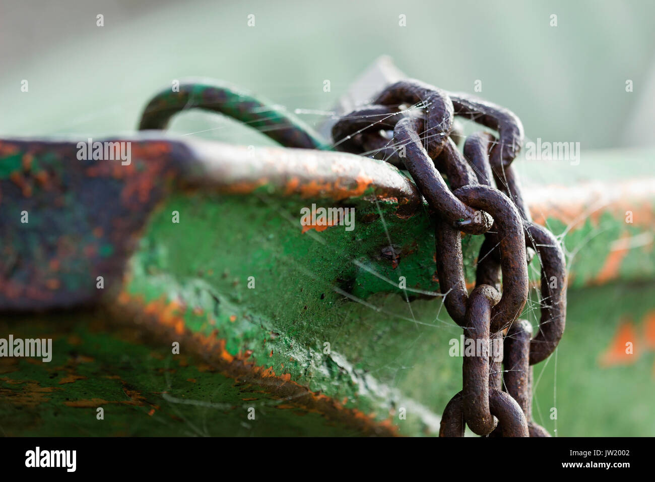 An old chain with a spider web Stock Photo - Alamy