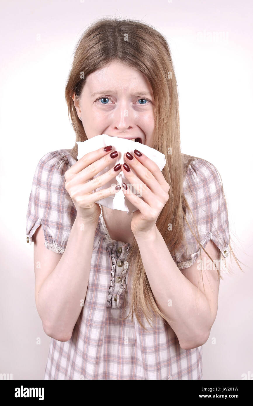 Young woman crying and holding paper tissue Stock Photo - Alamy