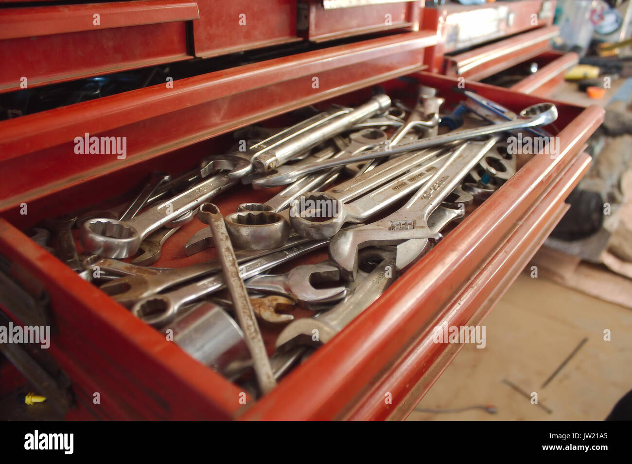 Shifters, spanners & other tools in an open drawer of a red toolbox in ...