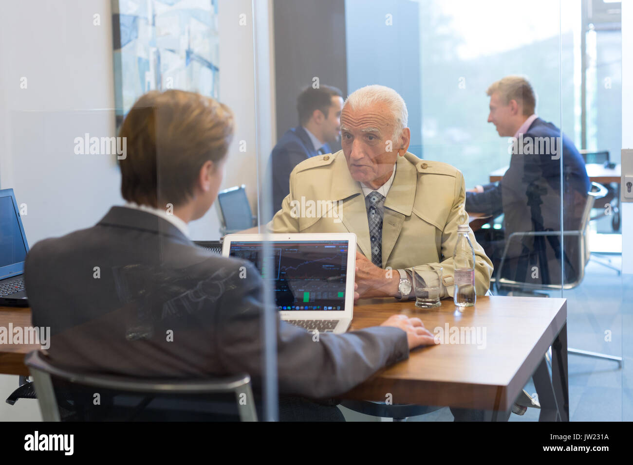 Financial advisor consulting senior client with his investment strategy ...