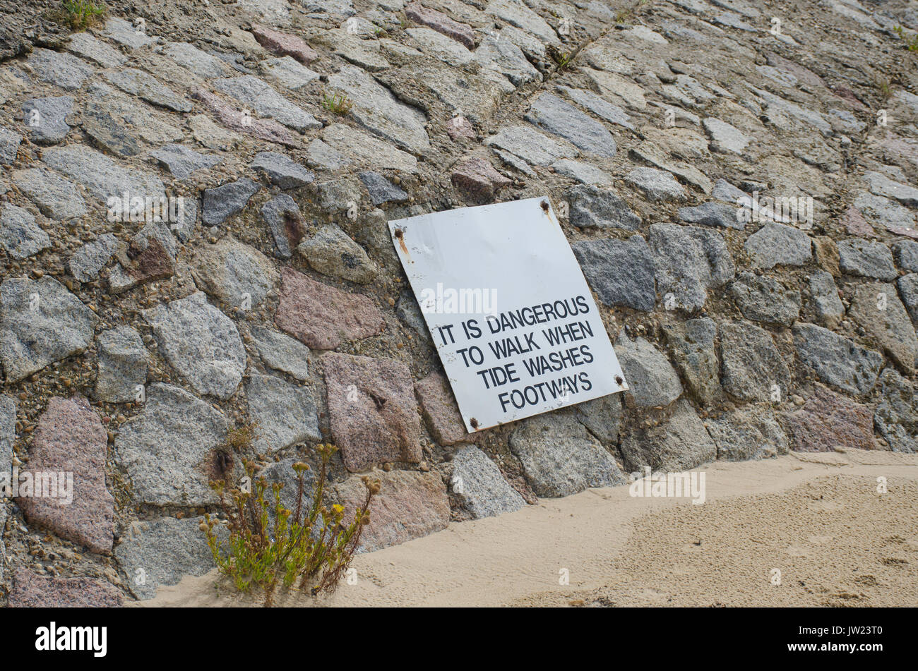 Warning sign on path being affected by coastal erosion Stock Photo - Alamy