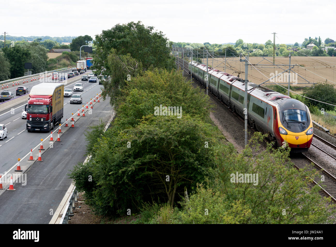 The West Coast Main Line alongside the M1 motorway in Northamptonshire ...