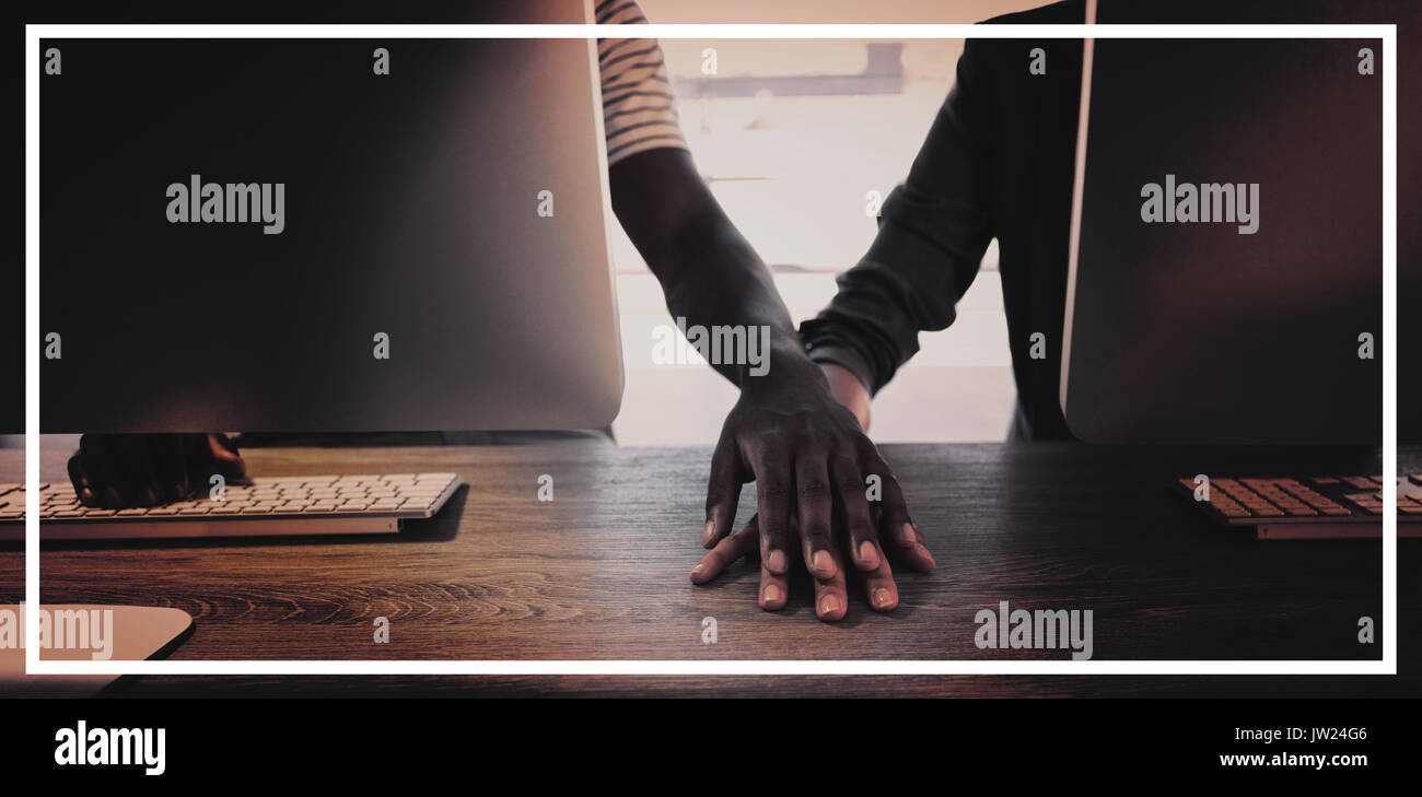 Executives holding hands at their desk in office Stock Photo - Alamy