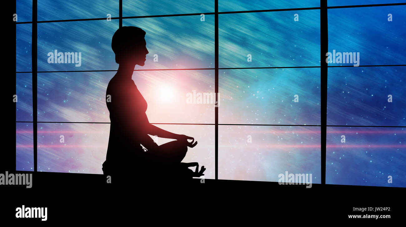 Side view of person practicing meditation against view of interior ...