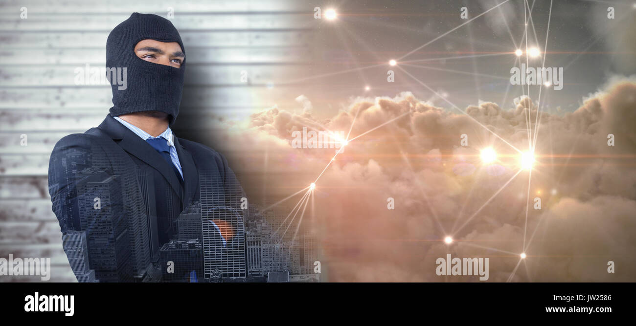 Male hacker standing with arms crossed against glowing dots with ...
