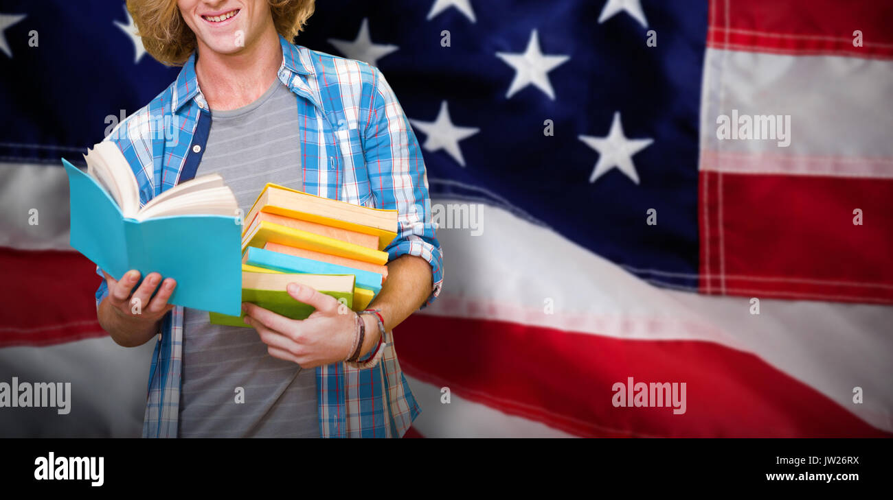 Student reading book against close-up of red and white american flag ...