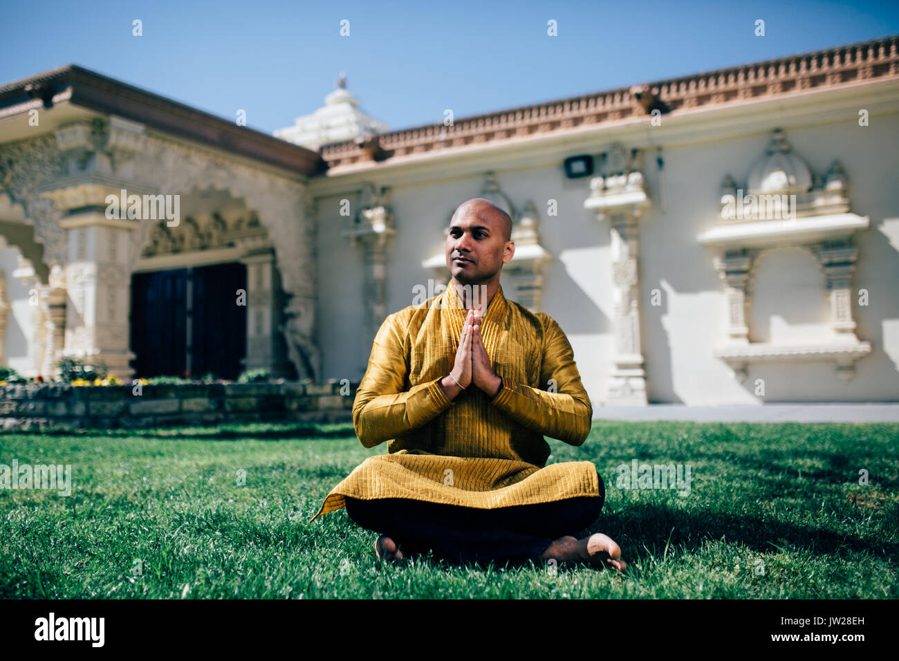 Handsom Indian Man Greeting Namaste, in Gold Kurta at the Temple Stock ...