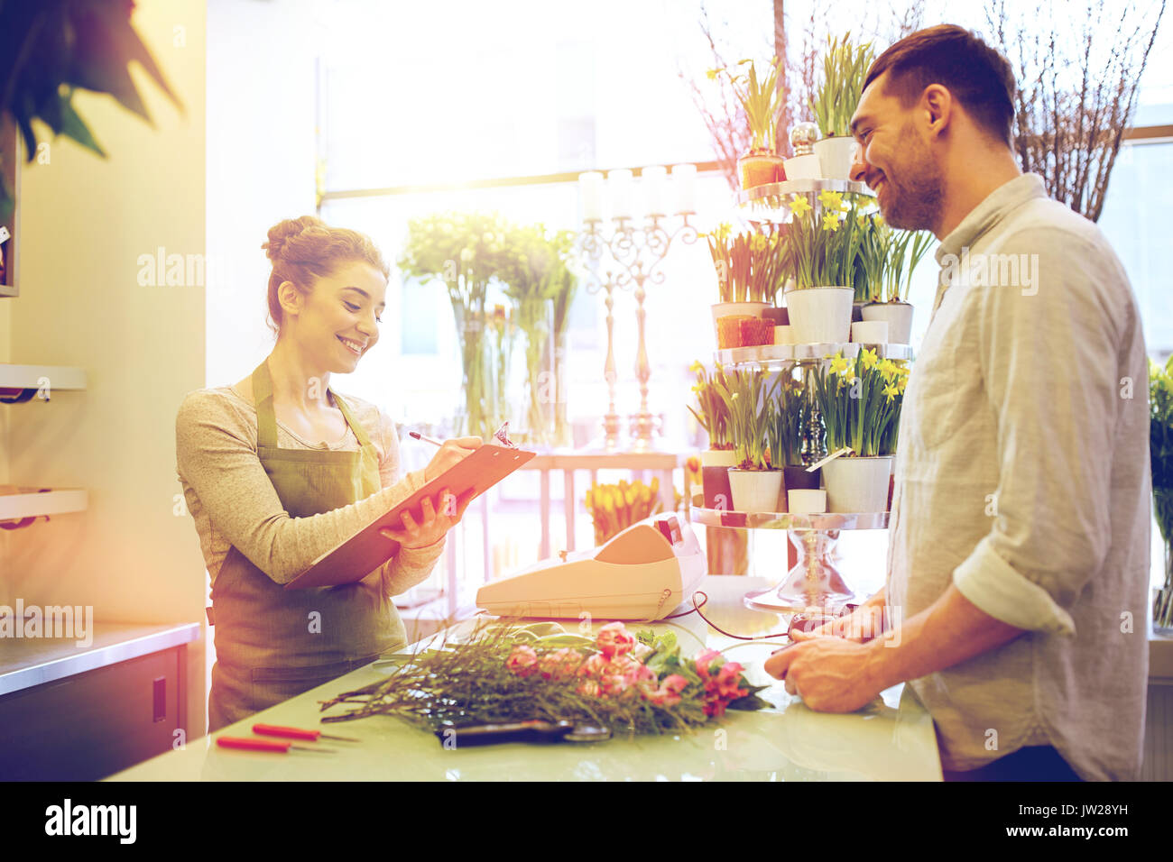 florist woman and man making order at flower shop Stock Photo - Alamy