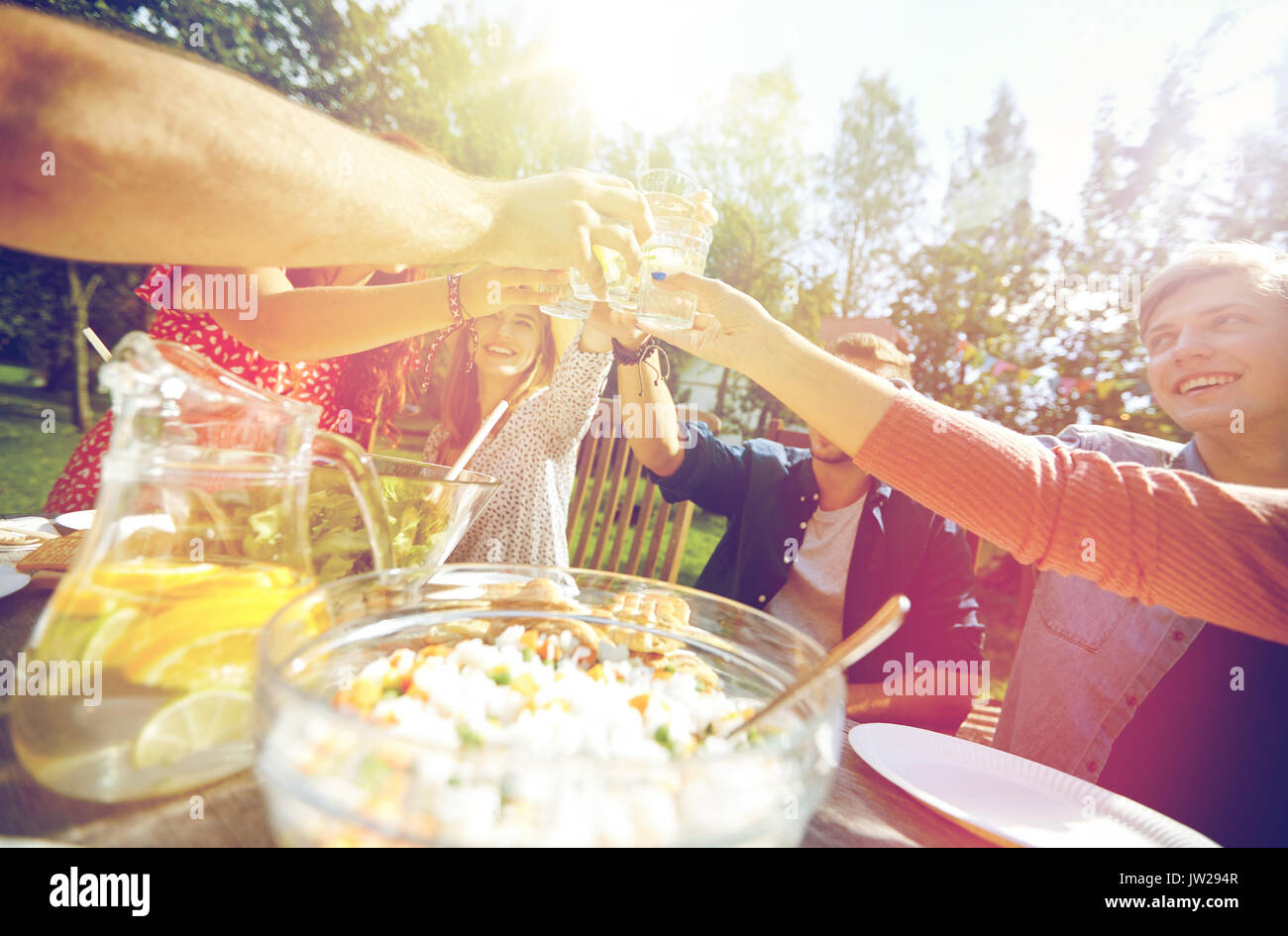 happy friends with drinks at summer garden party Stock Photo - Alamy