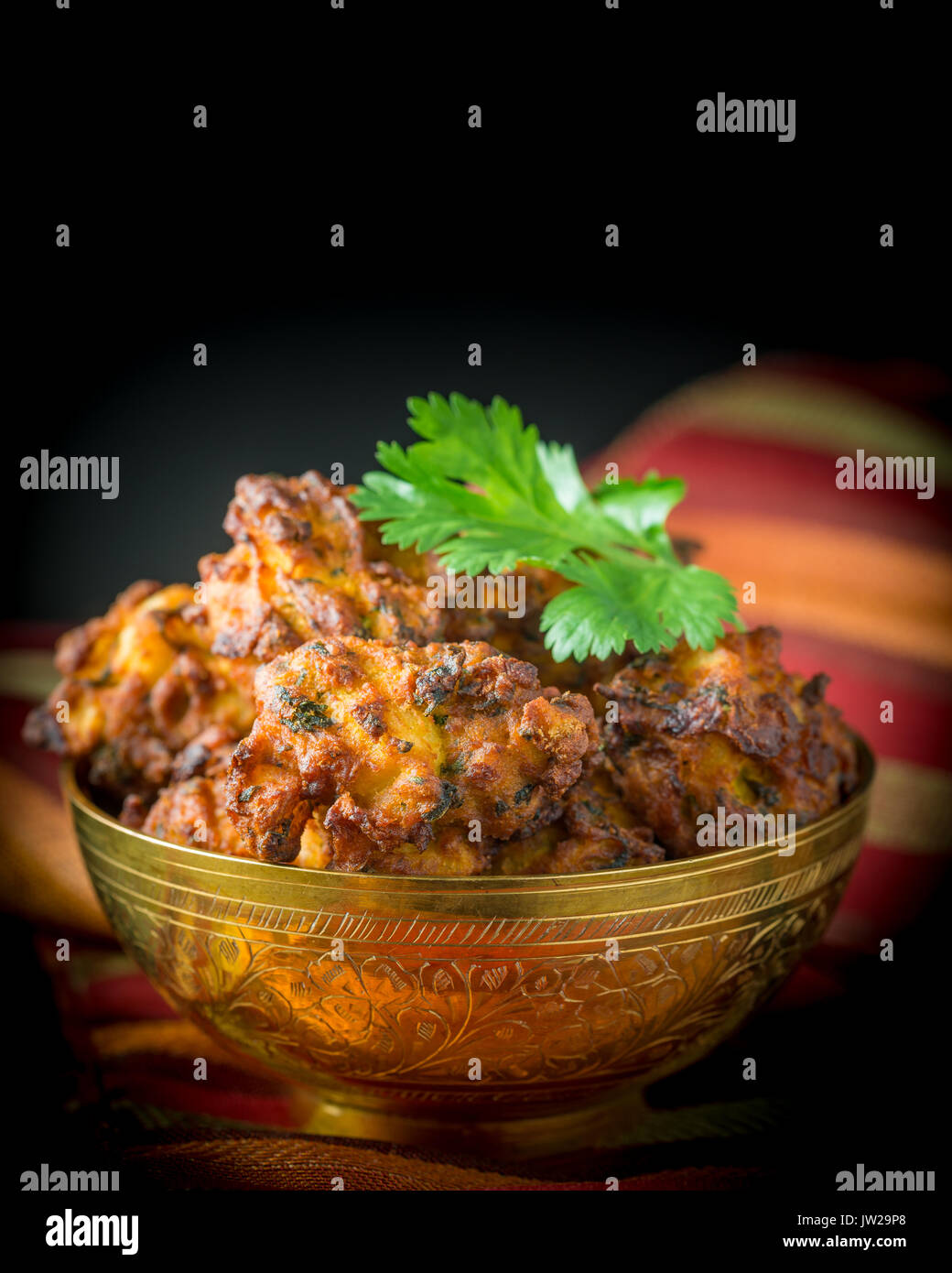 Pakoras are fried vegetable fritters that originated in India Stock ...