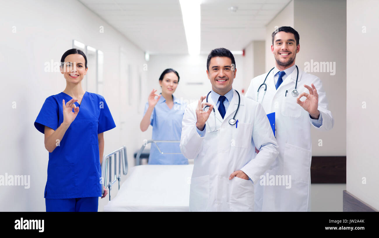 happy doctors with gurney showing ok at hospital Stock Photo - Alamy