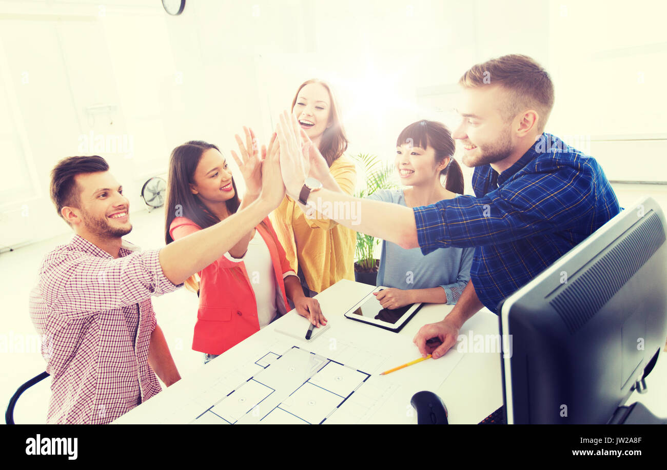 creative team making high five at office Stock Photo - Alamy
