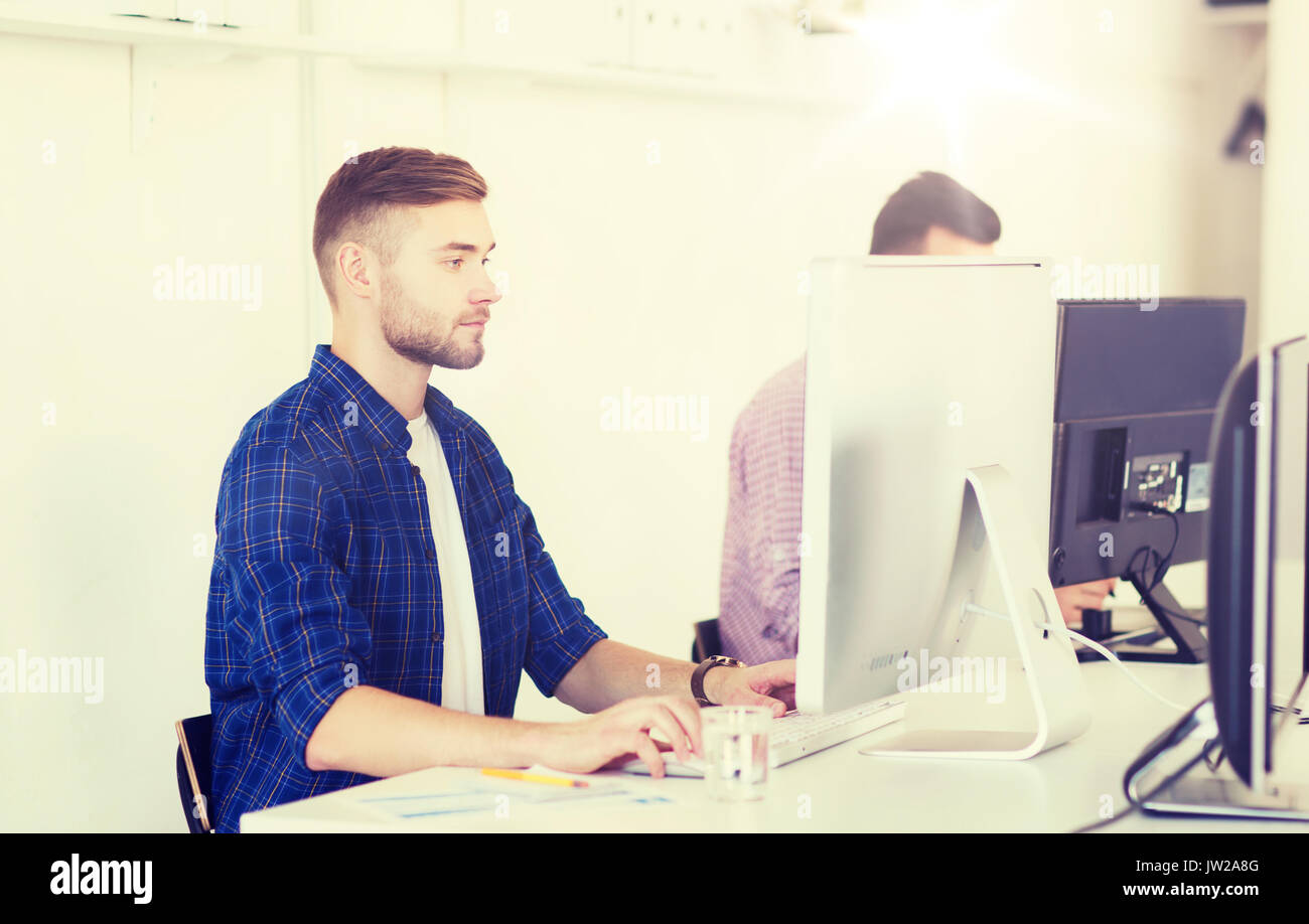 creative man or student with computer at office Stock Photo - Alamy