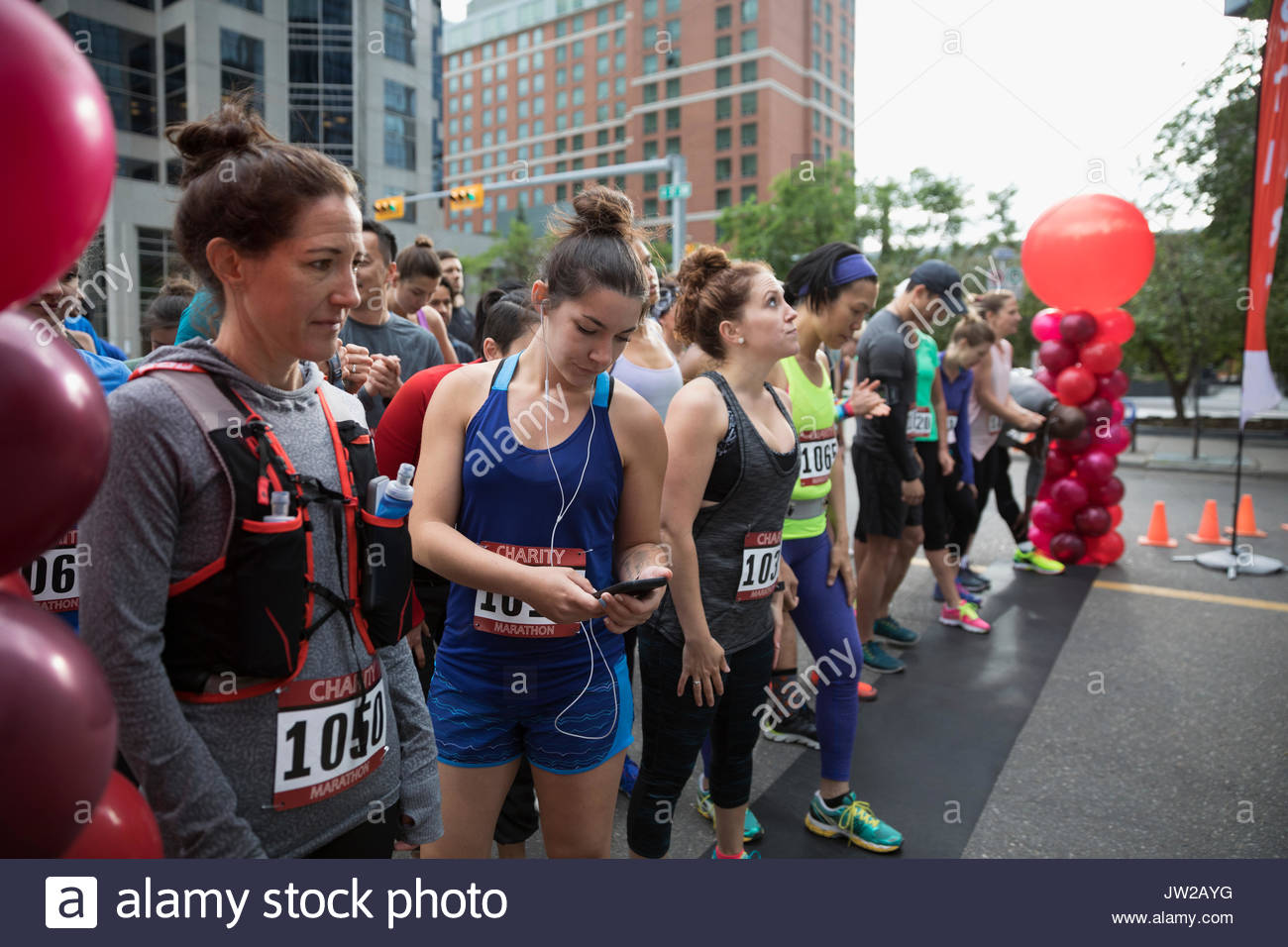 Marathon runners ready, waiting at starting line on urban street Stock ...