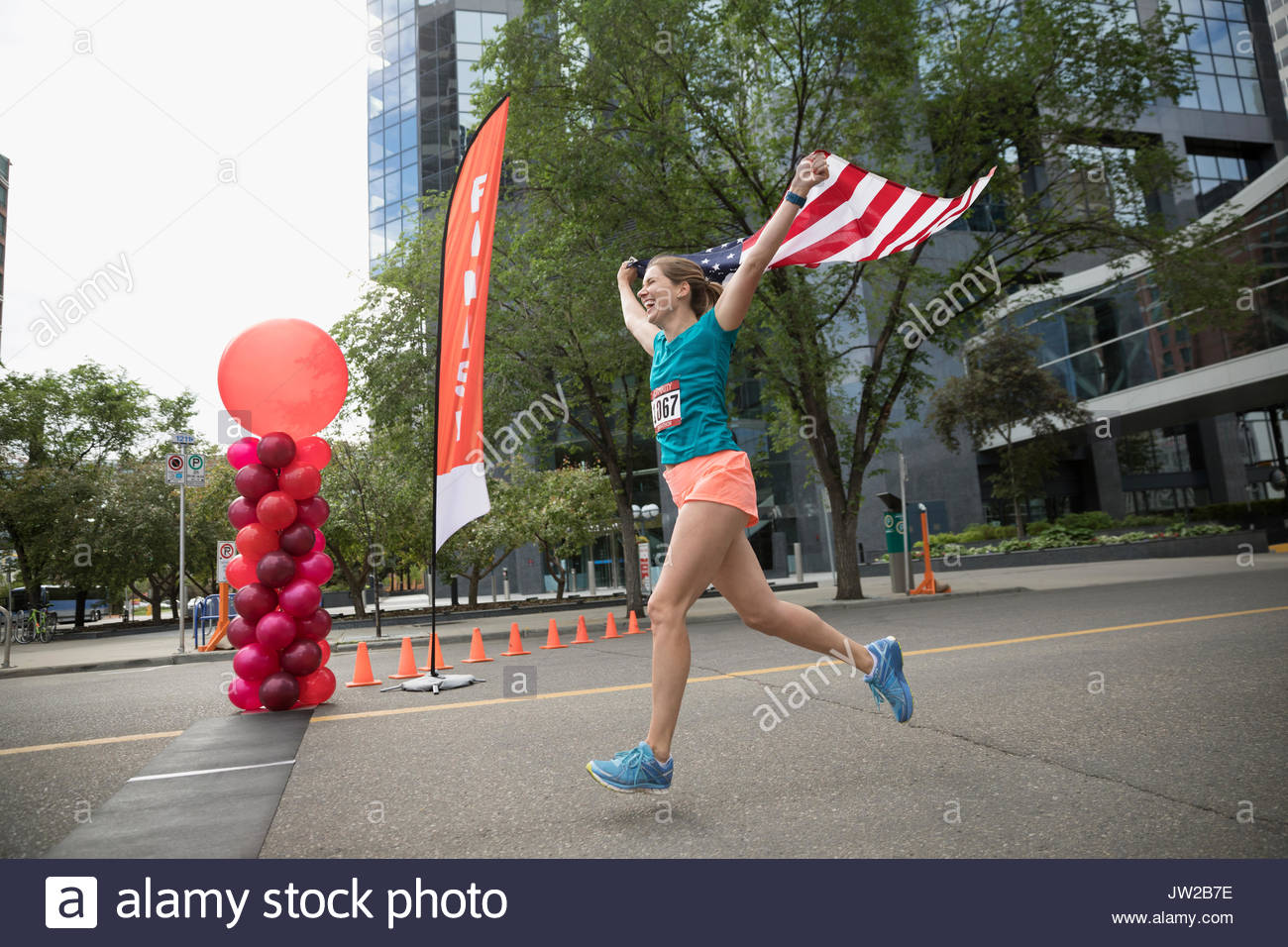 Female marathon runner running with american flag hi-res stock ...