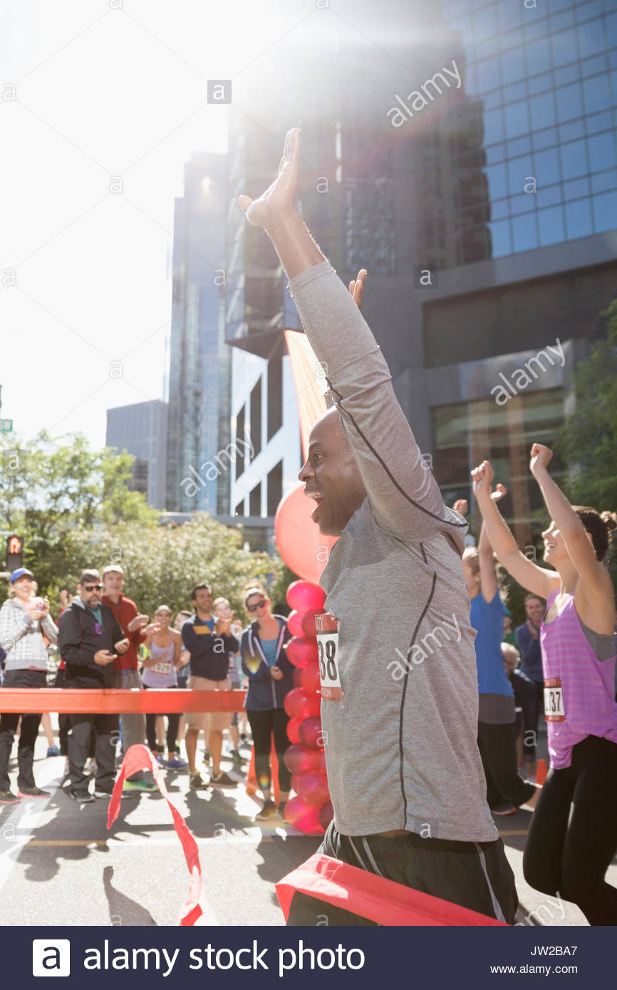 Man crossing finishing line hi-res stock photography and images - Alamy
