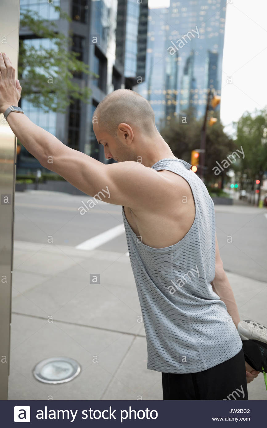 Young man standing on one leg hi-res stock photography and images - Alamy