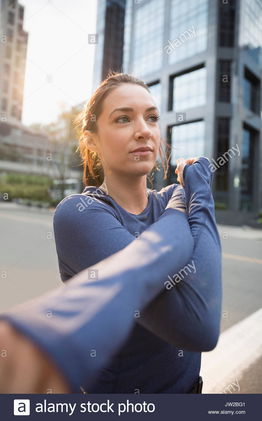 Young female jogger stretching hi-res stock photography and images - Alamy
