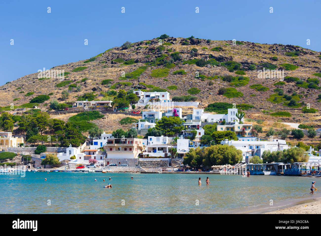 Beautiful beach of Kini in Syros island, Greece against a clear blue ...