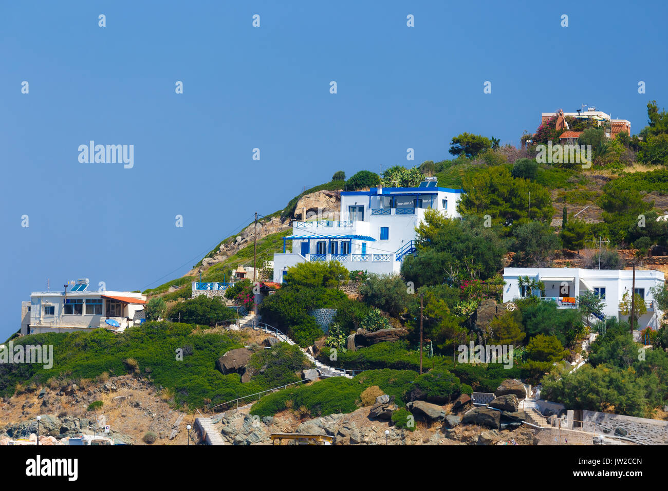 Beautiful beach of Kini in Syros island, Greece against a clear blue ...