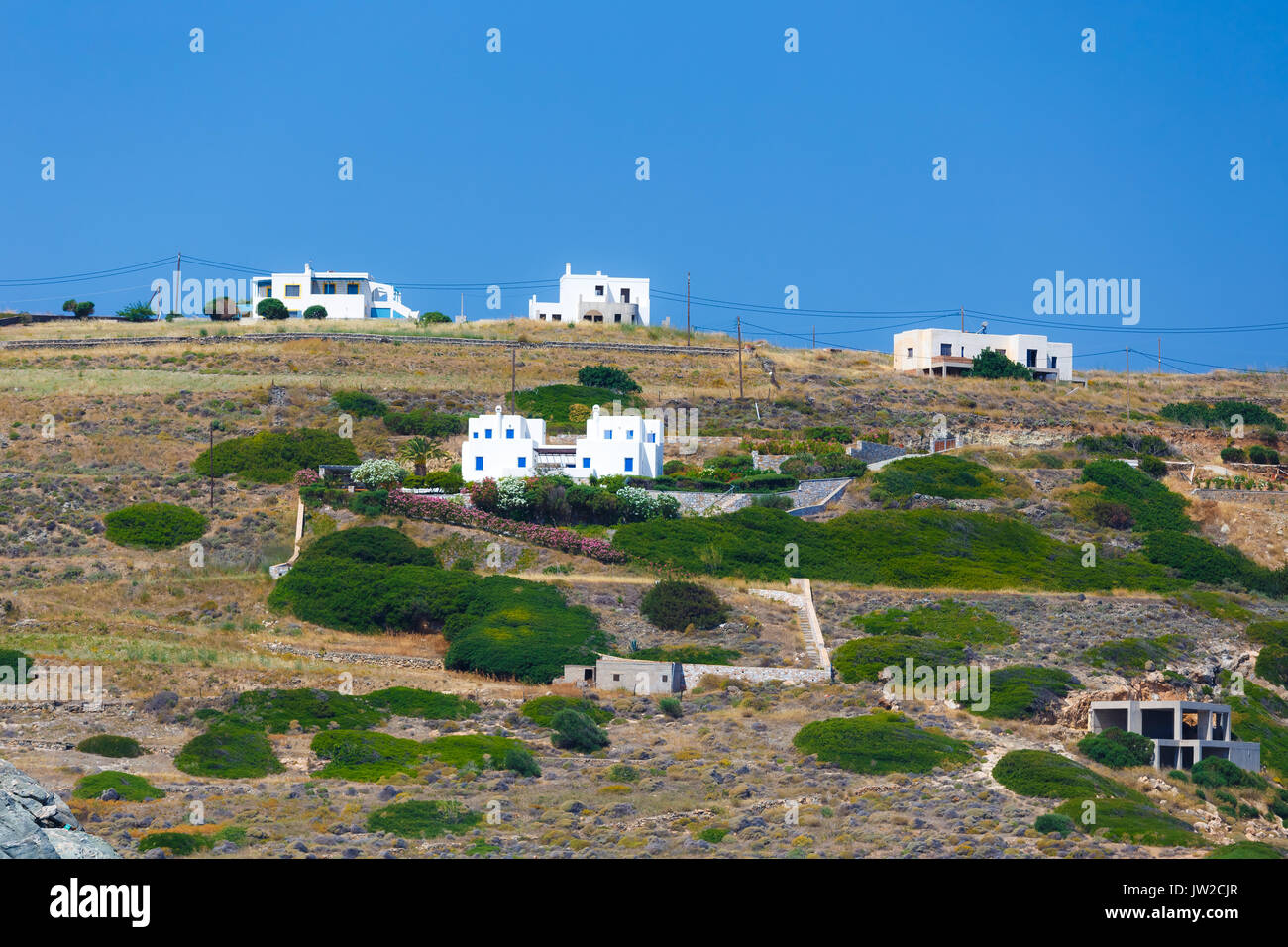 Beautiful beach of Kini in Syros island, Greece against a clear blue ...