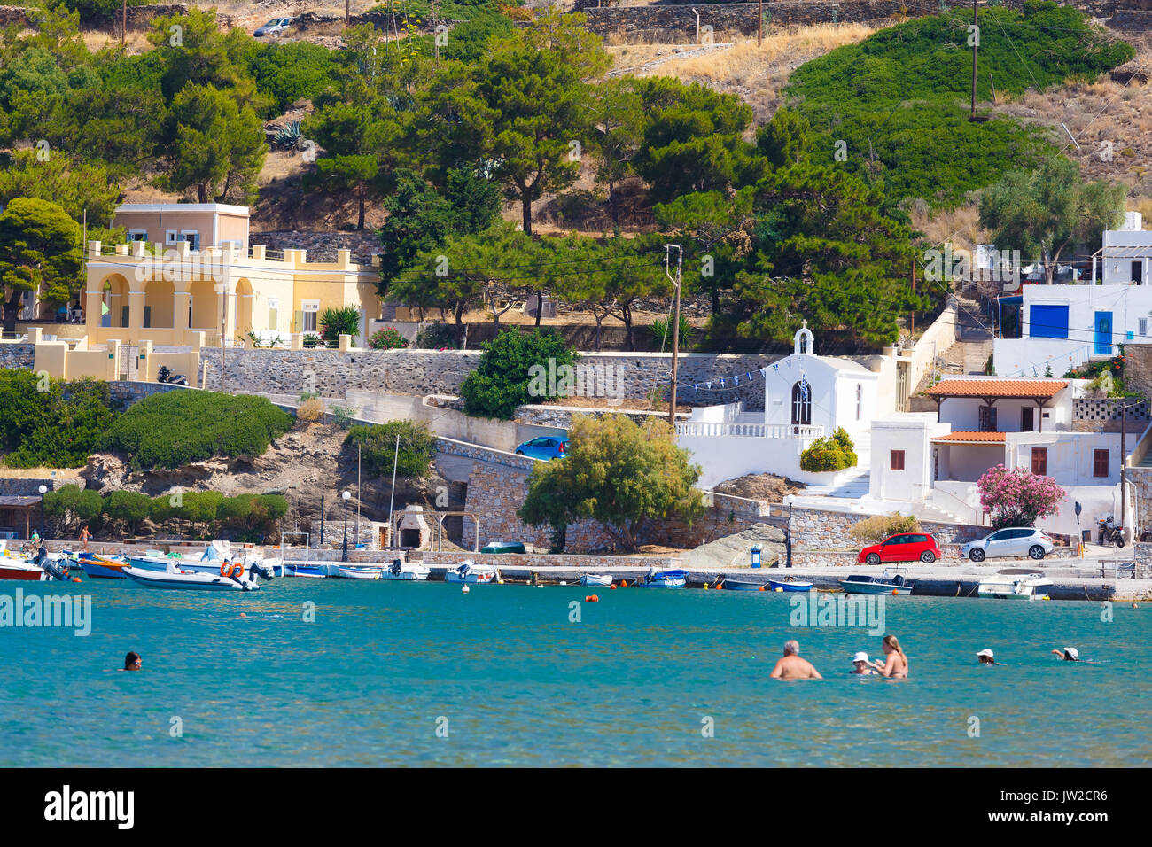 Beautiful beach of Kini in Syros island, Greece against a clear blue ...