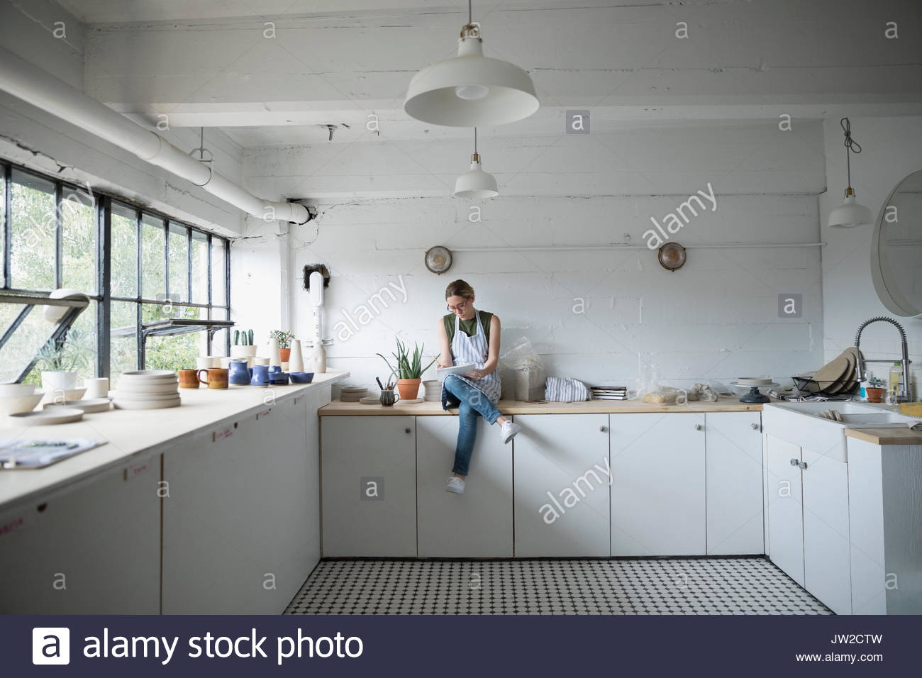 Sitting on workbench in art studio hi-res stock photography and images ...