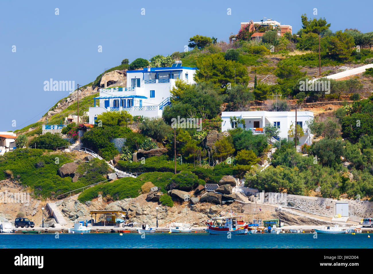 Beautiful beach of Kini in Syros island, Greece against a clear blue ...