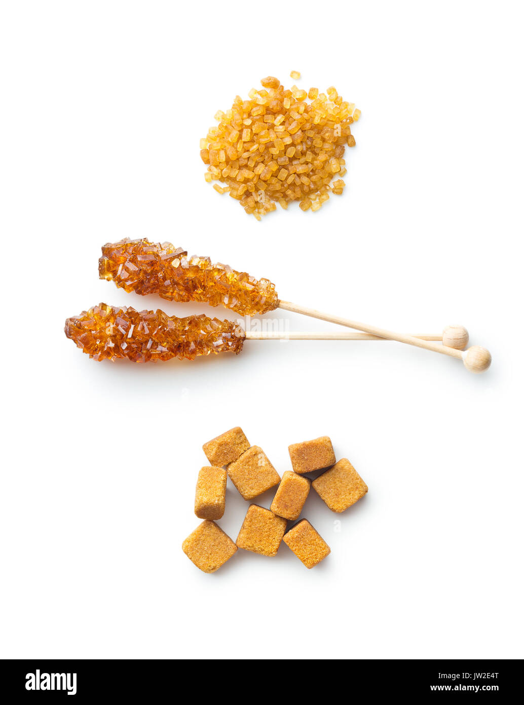 Brown cane sugar, cube sugar and crystalic sugar on wooden sticks ...