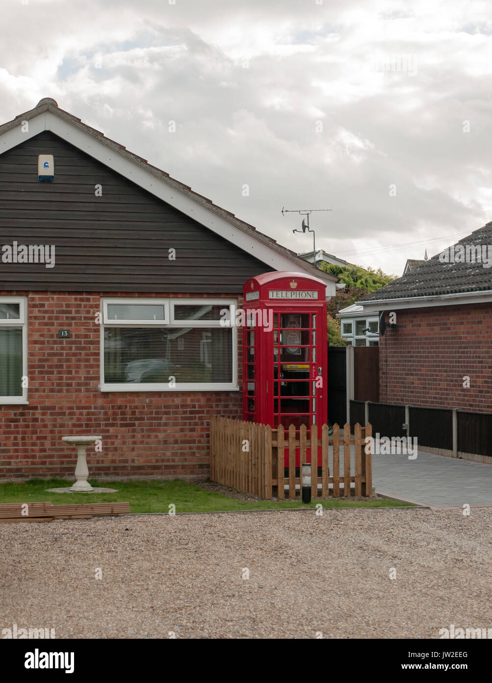 red uk telephone box outside of house; UK Stock Photo - Alamy