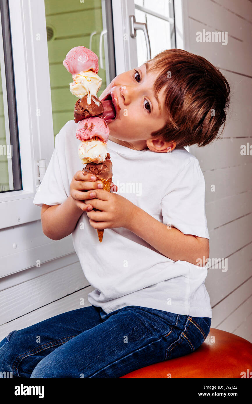 Photo of a 6 year old eating a tall ice cream cone wit six scoops of ...