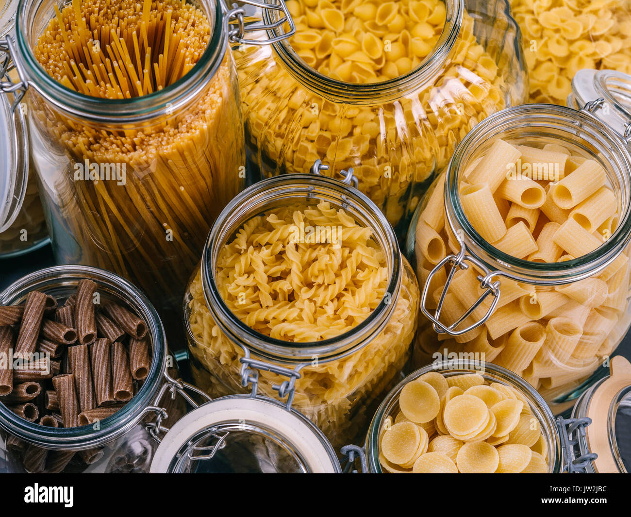 Photo of different pasta types in large glass jars Stock Photo - Alamy