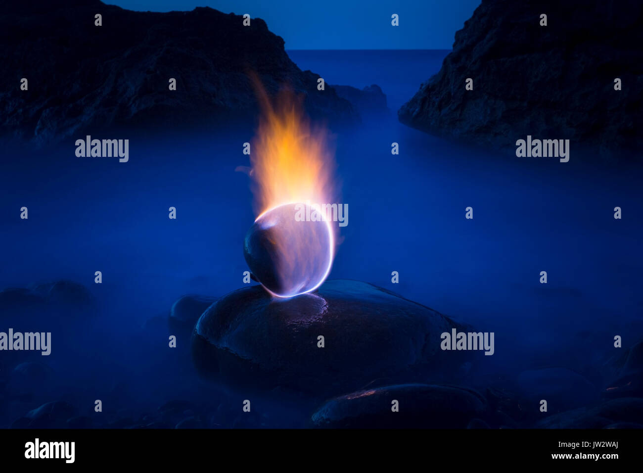 flaming rock on the shore Stock Photo - Alamy