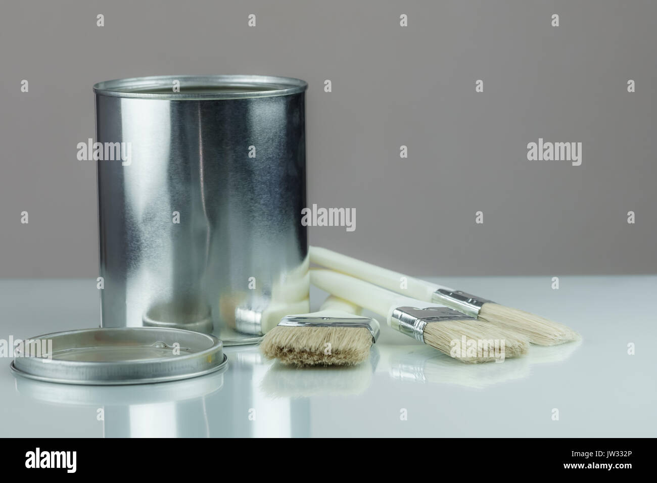 Paint bucket with brush isolated on white Stock Photo - Alamy