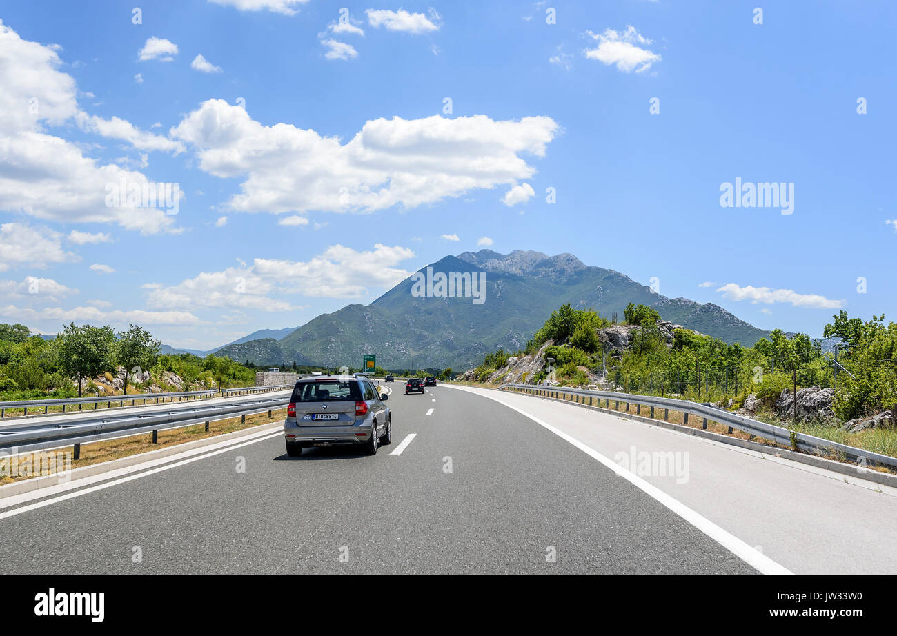 Cars speeding on the Autobahn among mountain scenery Stock Photo - Alamy