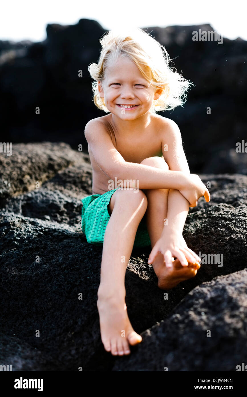Boy Sitting On Rocks Beach High Resolution Stock Photography and Images ...