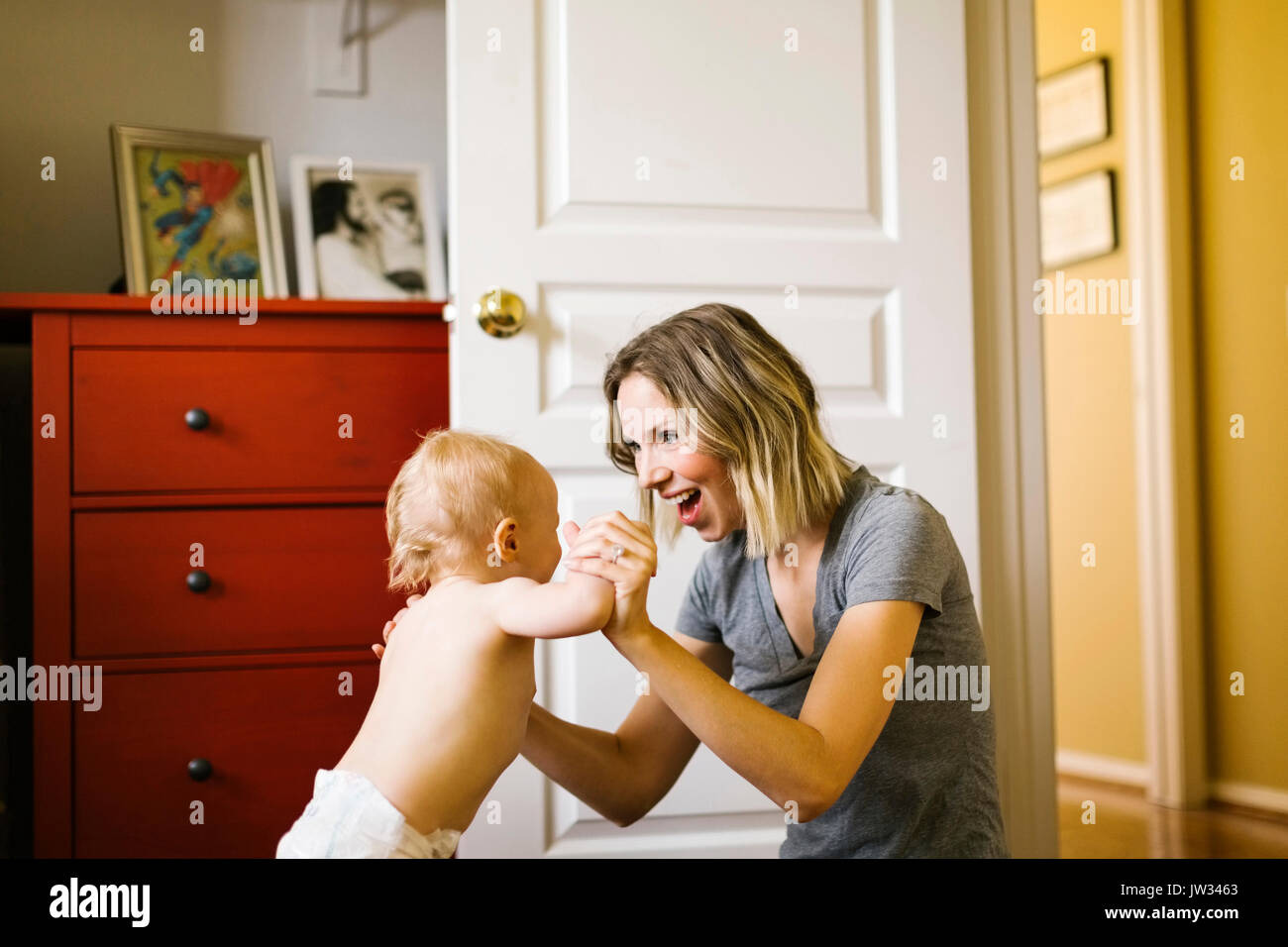 Baby boy (12-17 months) taking first steps with mother Stock Photo - Alamy