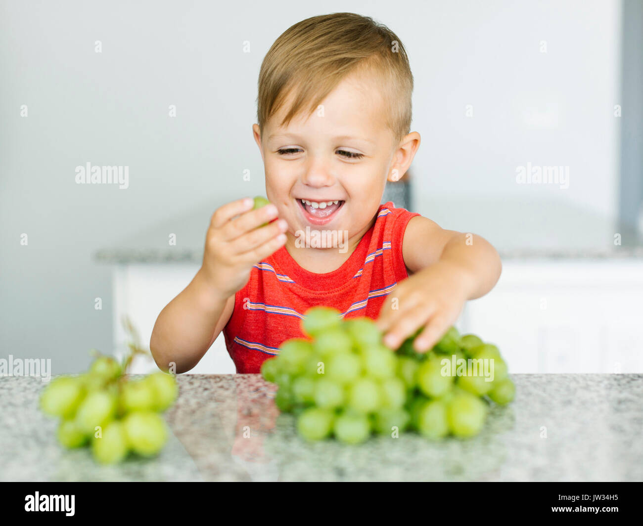 Boy eating grapes hi-res stock photography and images - Alamy