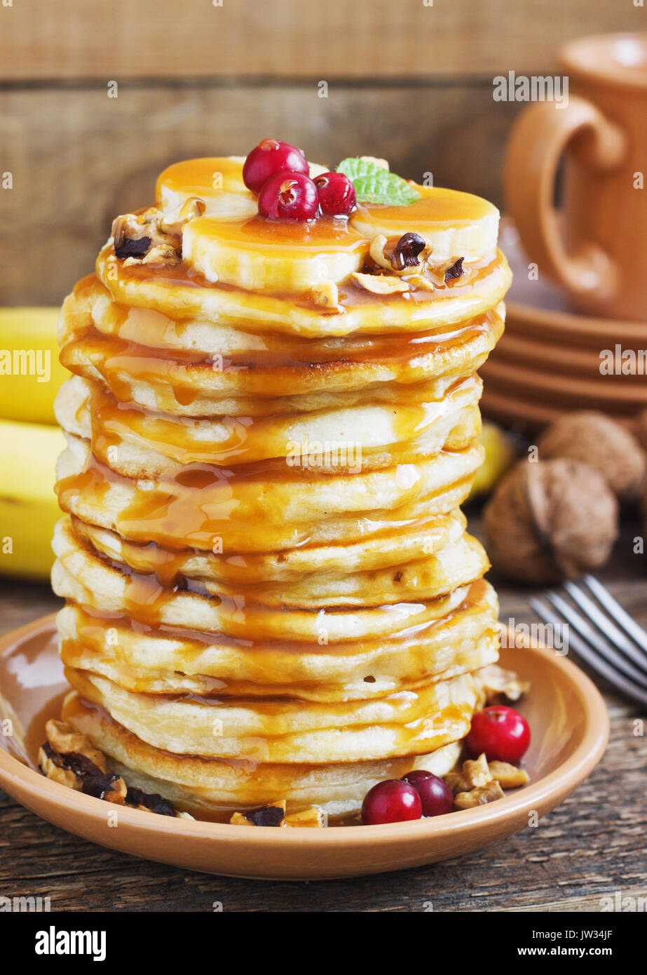 Pancakes with banana,walnut and caramel for a breakfast on a dark ...