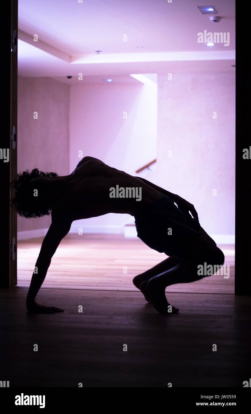 Yoga teacher doing backbend bridge flexibility and strength asana ...