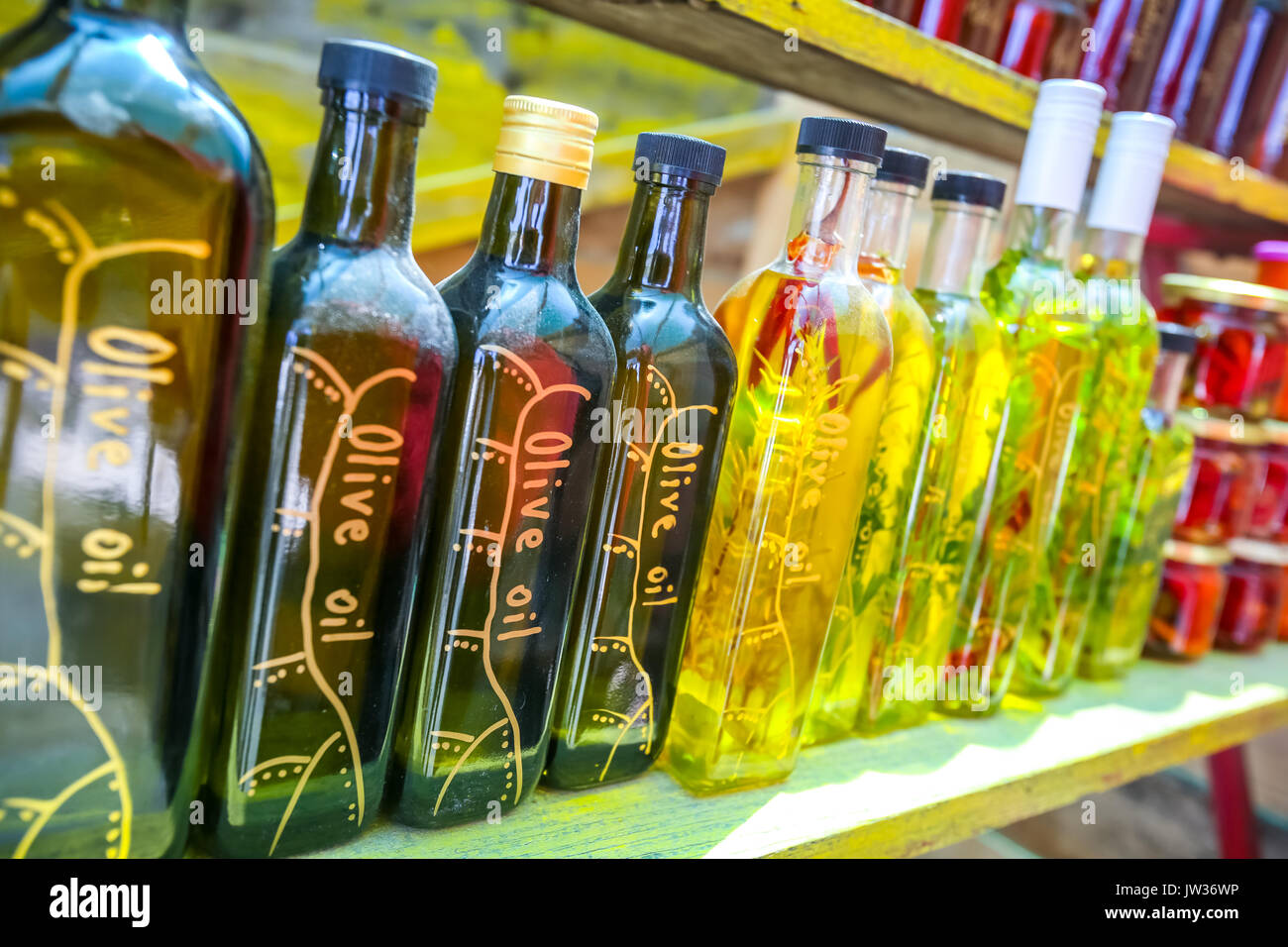 Homemade olive oil bottles displayed at a food stand Stock Photo - Alamy
