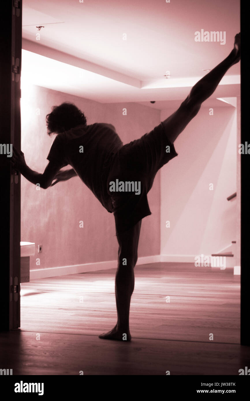 Male yoga teacher doing splits leg stretching flexibility calisthenics ...