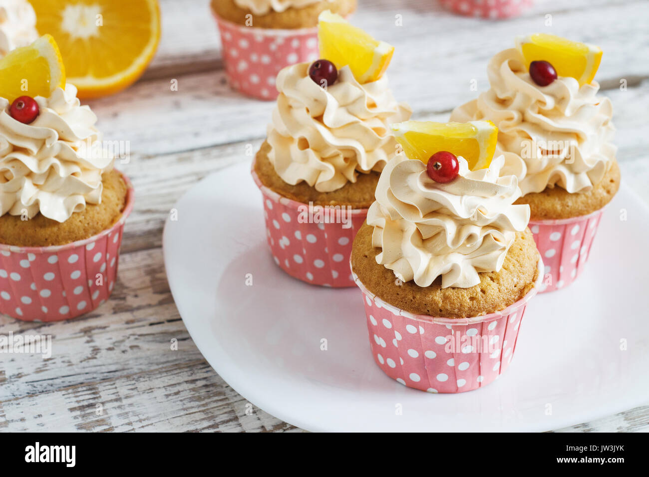 Christmas cupcakes with whipped cream topping and cranberrieson ...