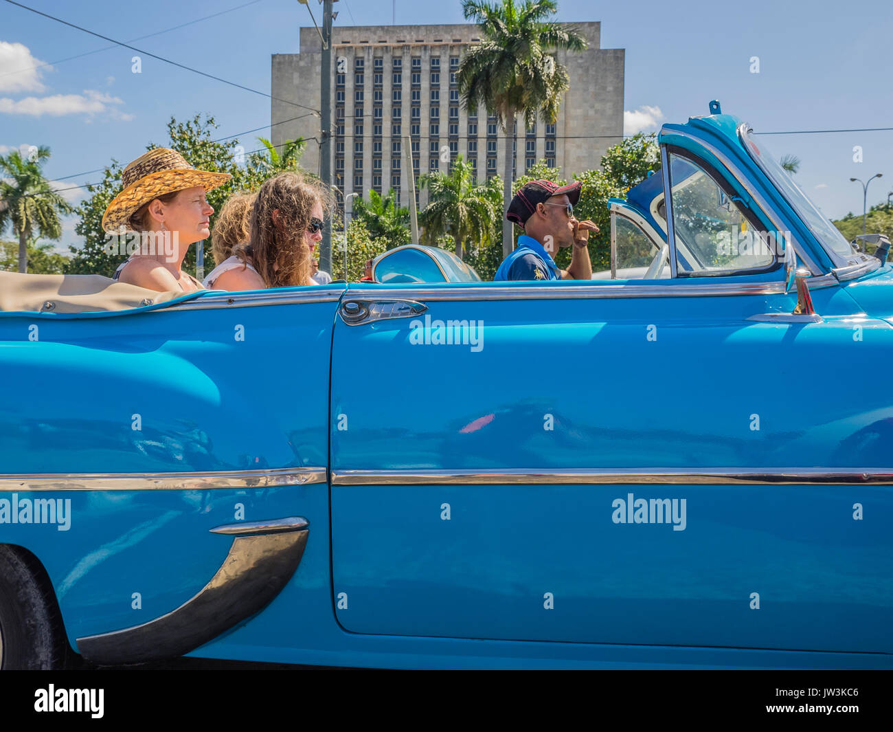 Three female Caucasian American tourists ride in the back seat of a ...