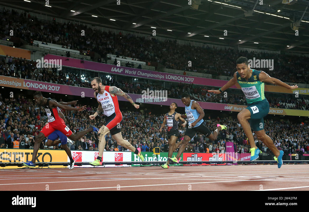 Turkey's Ramil Guliyev (second from left) dips on the finish line to ...
