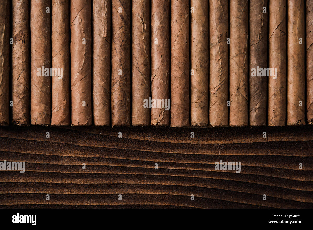 Cuban cigars close up on wooden table, border background. Directly from ...