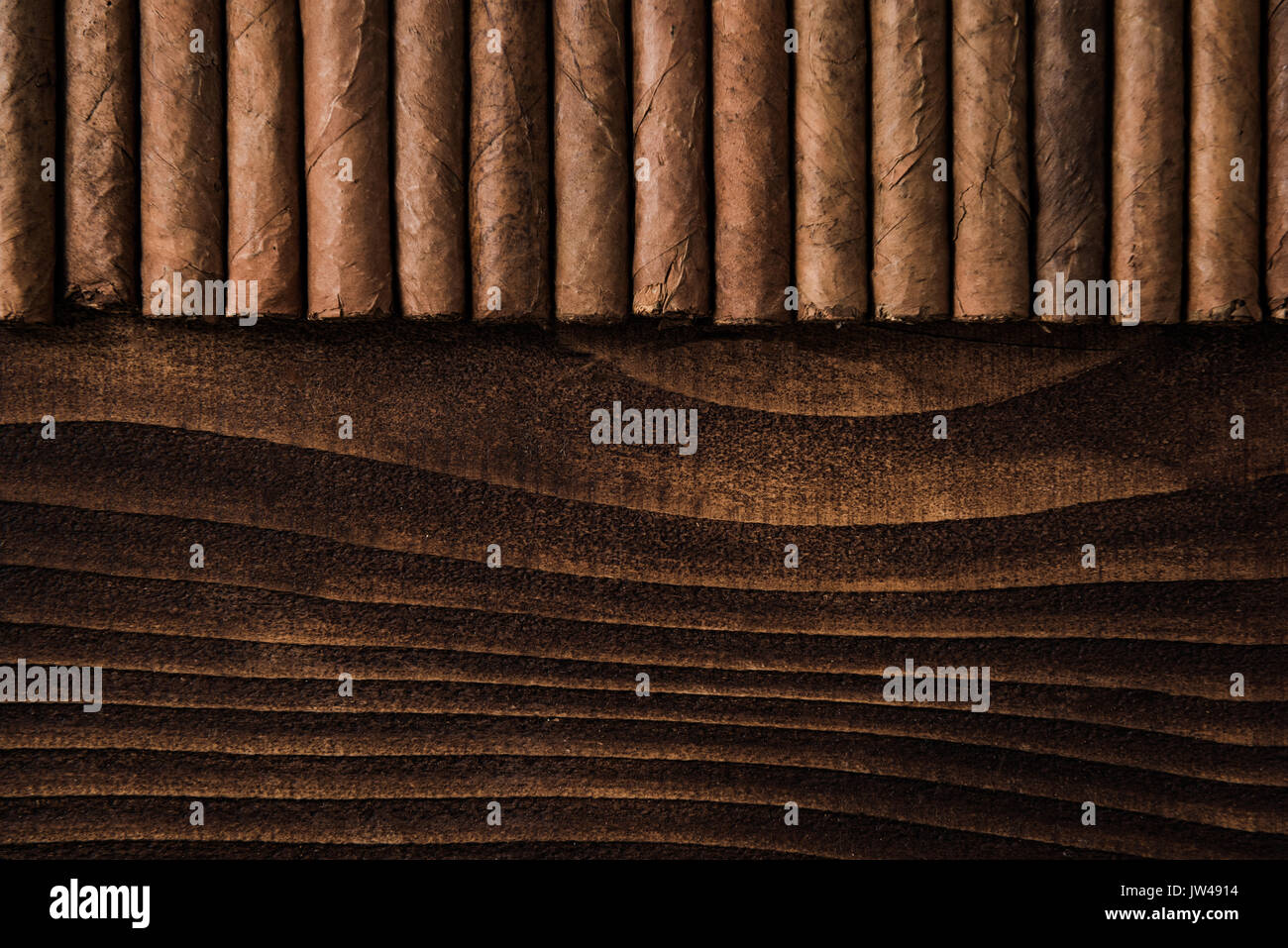 Cuban cigars close up on wooden table, border background. Directly from ...