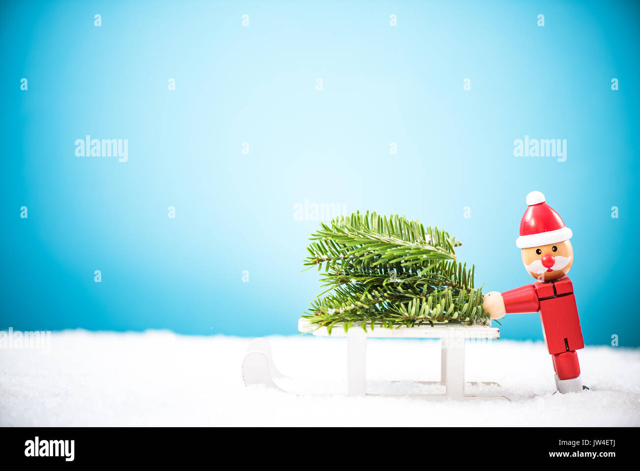 Funny Santa carry Christmas tree in snow Stock Photo - Alamy